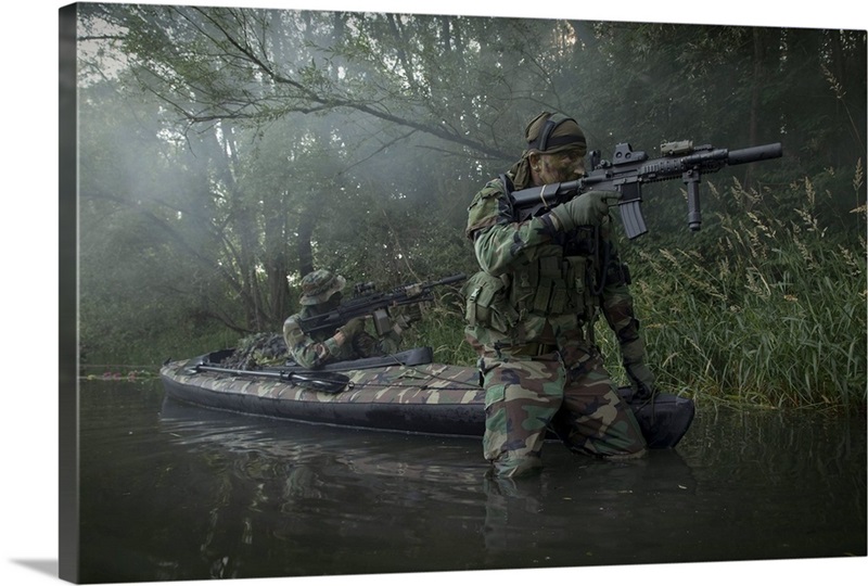 Navy SEALs navigate the waters in a folding kayak during jungle warfare ...