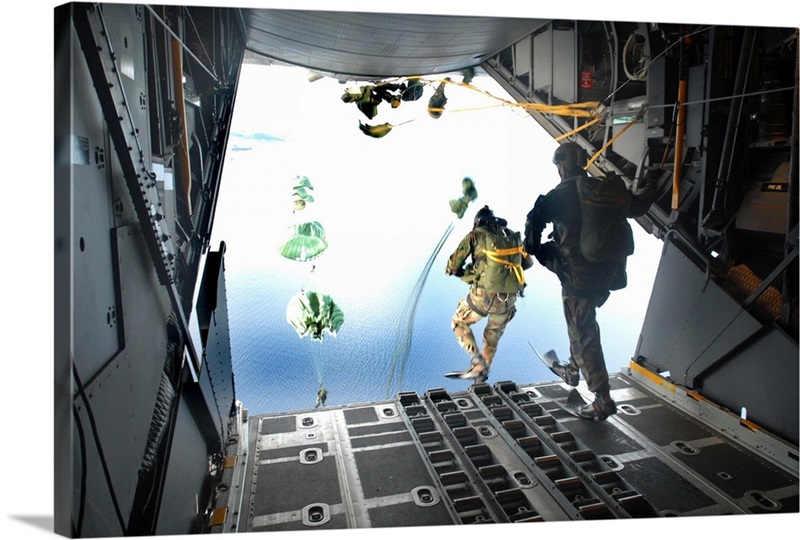 Pararescuemen perform a static-line jump out of a C-130 Hercules ...