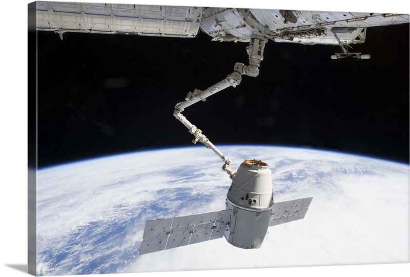 The docking of SpaceX Dragon to the International Space Station above ...