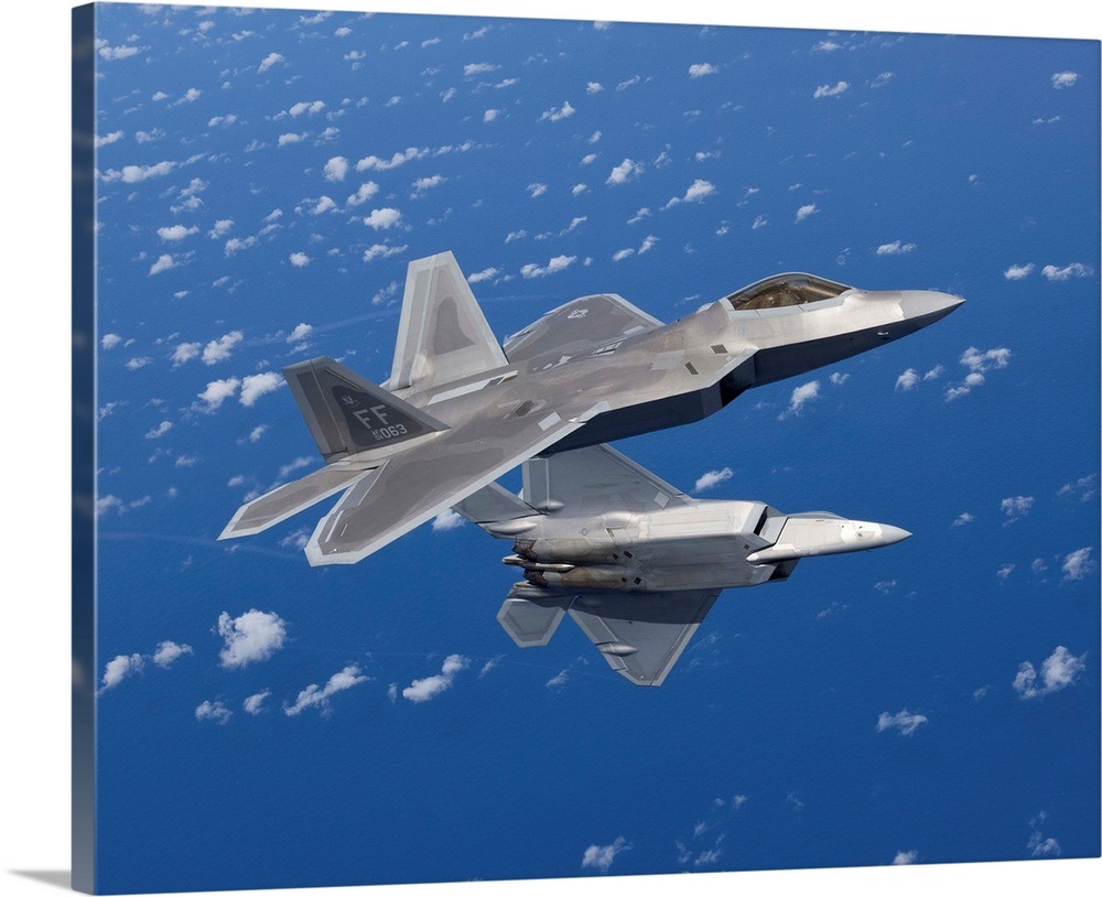 Two F-22 Raptors maneuver while flying a training mission over Japan ...