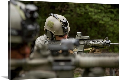 U.S. Special Forces soldiers provide security with automatic rifles ...