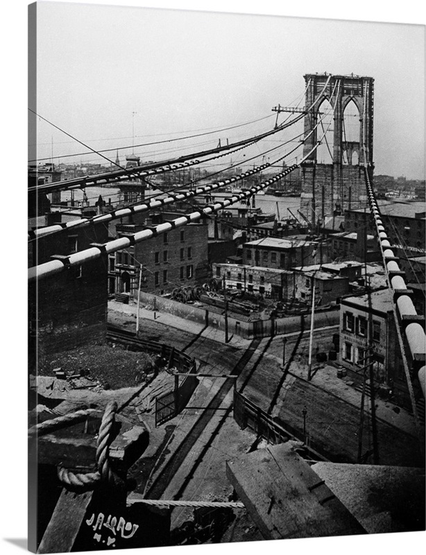 The Brooklyn Bridge under construction over the East River in New York ...