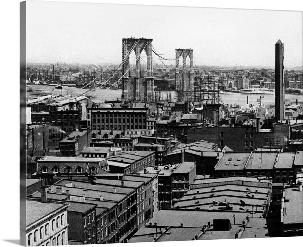 The Brooklyn Bridge under construction over the East River in New York ...