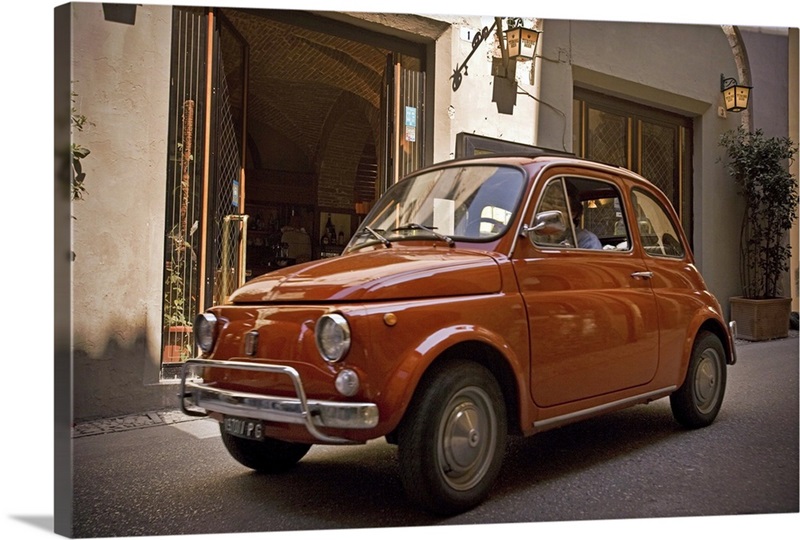 A small red car drives through the narrow streets in Italy | Great Big ...