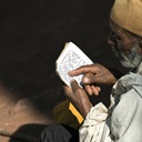 Ethiopia, Amhara, Lalibela, Priest reading an old Bible, Bete Maryam ...